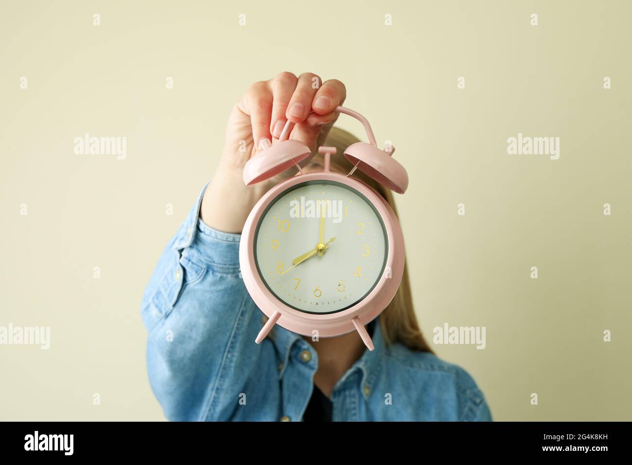 Woman holds up alarm clock hi-res stock photography and images - Alamy