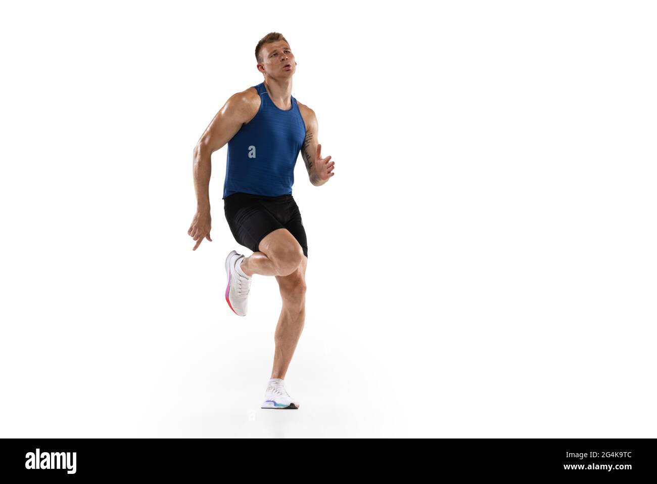 Caucasian professional male athlete, runner training isolated on white ...