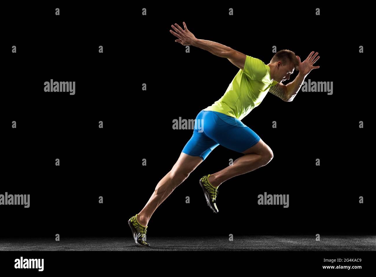 Caucasian professional male athlete, runner training isolated on black ...