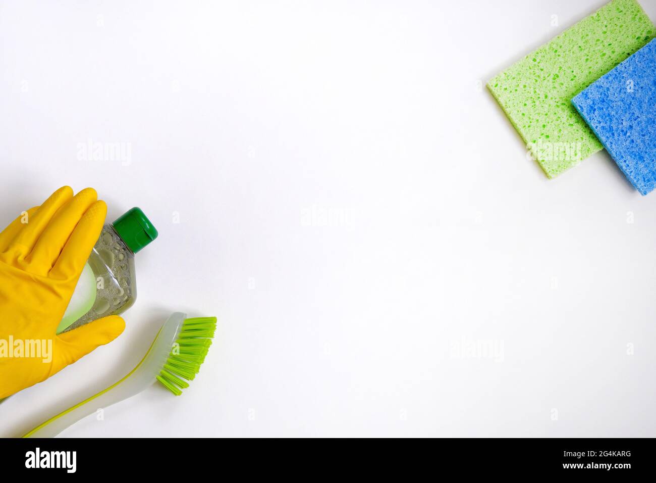 Set of green and yellow cleaning supplies on white background ...