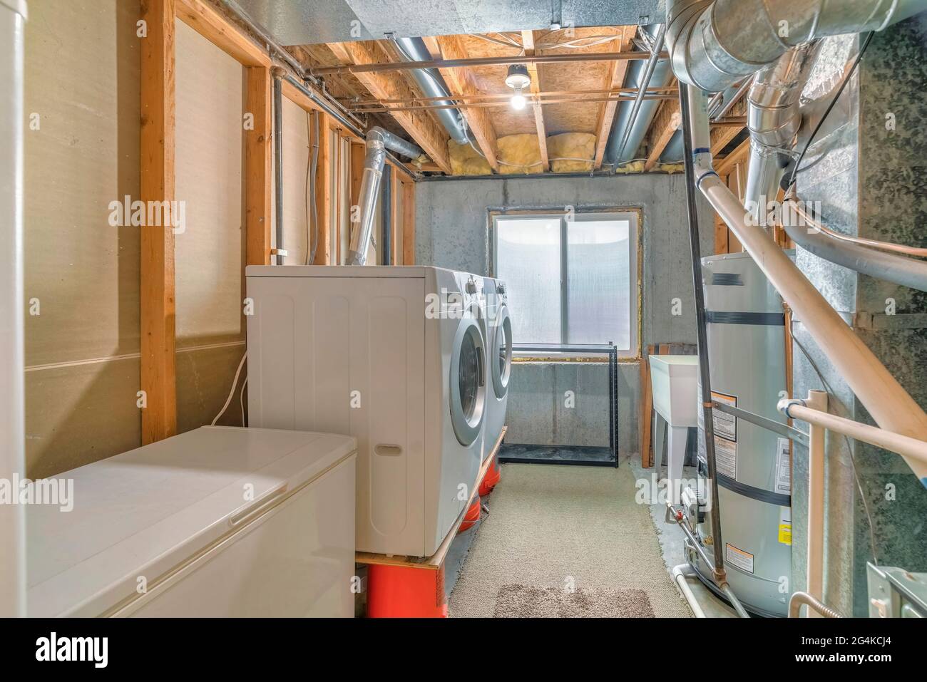 Laundry room with two washing machines and wooden ceiling Stock Photo ...