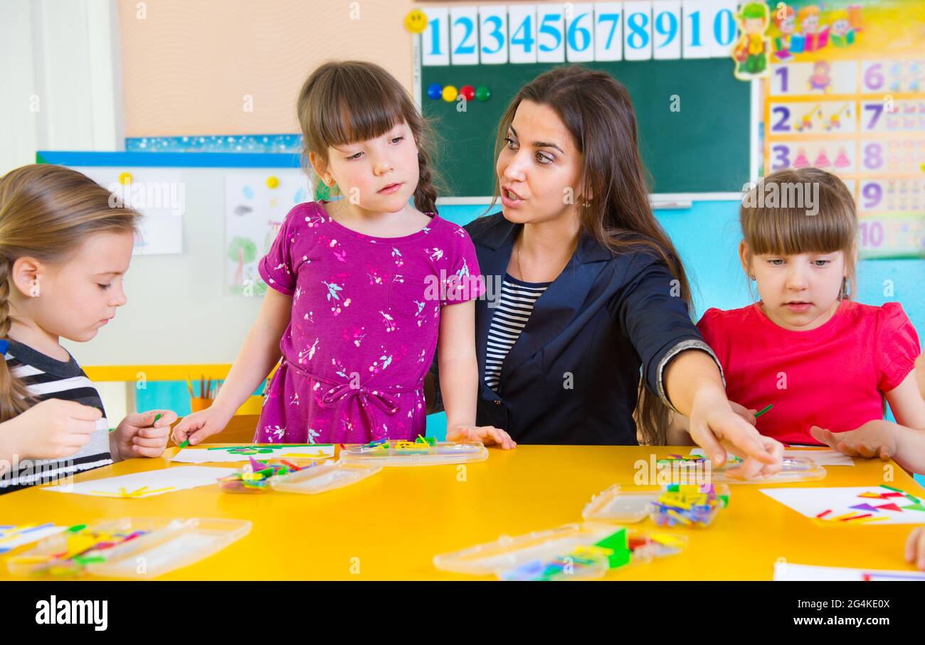 Cute little children on lesson at kindergarten Stock Photo - Alamy