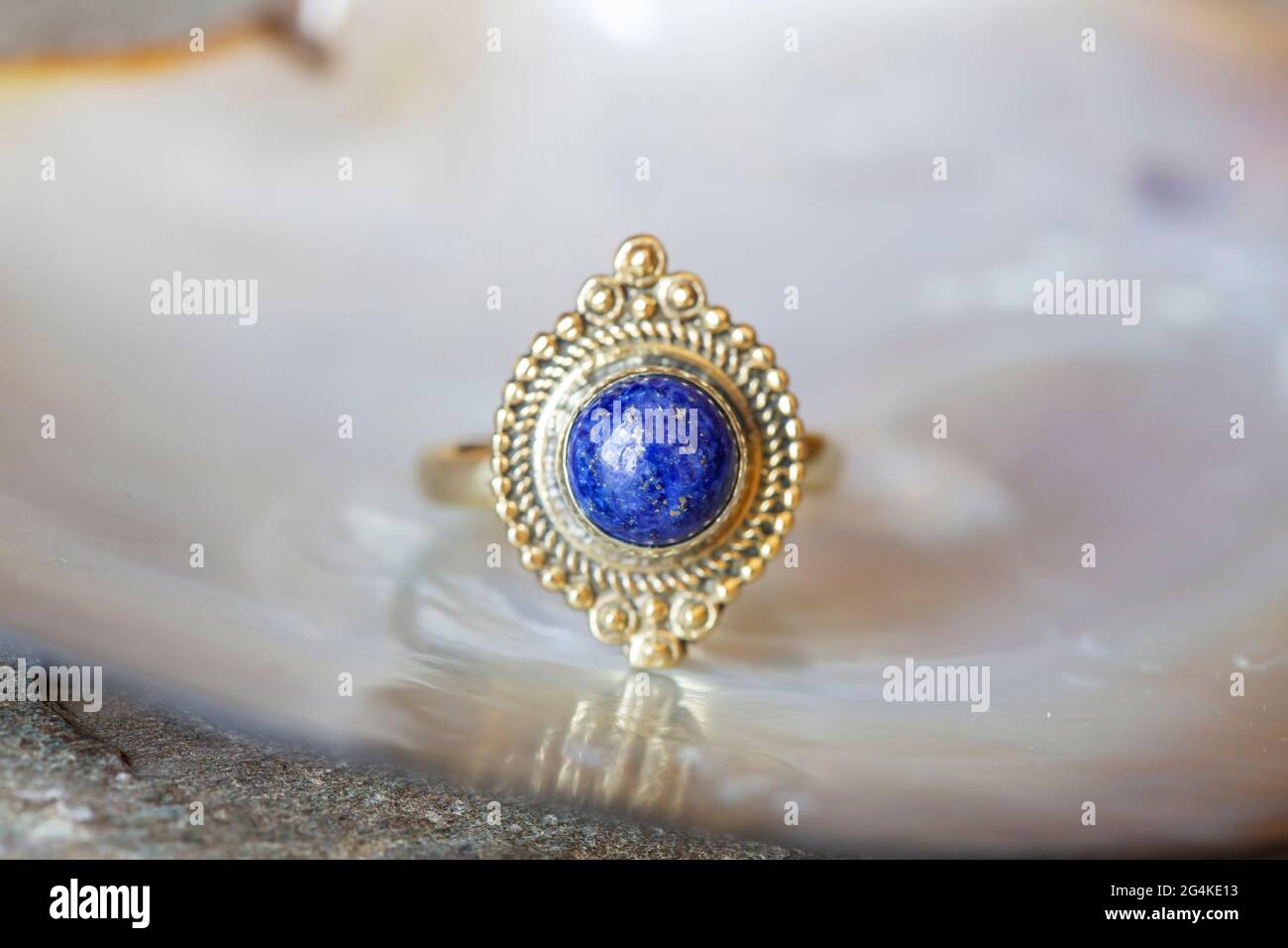 Brass ring in Indian oriental style on natural neutral shell background ...