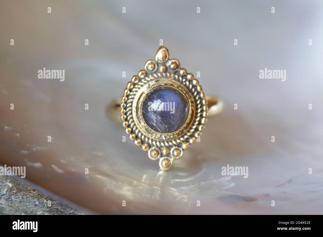 Brass ring in Indian oriental style on natural neutral shell background ...