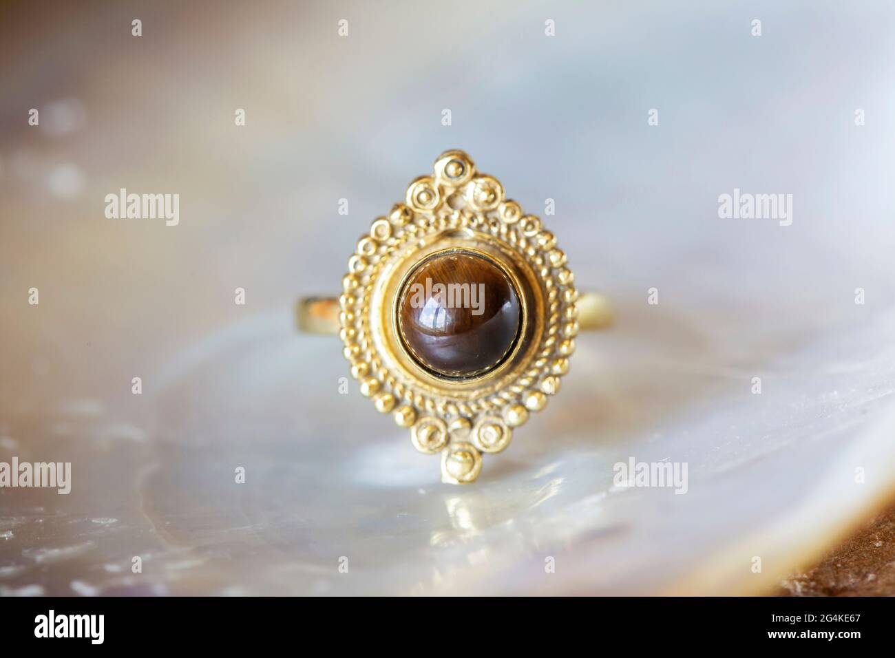 Brass ring in Indian oriental style on natural neutral shell background ...