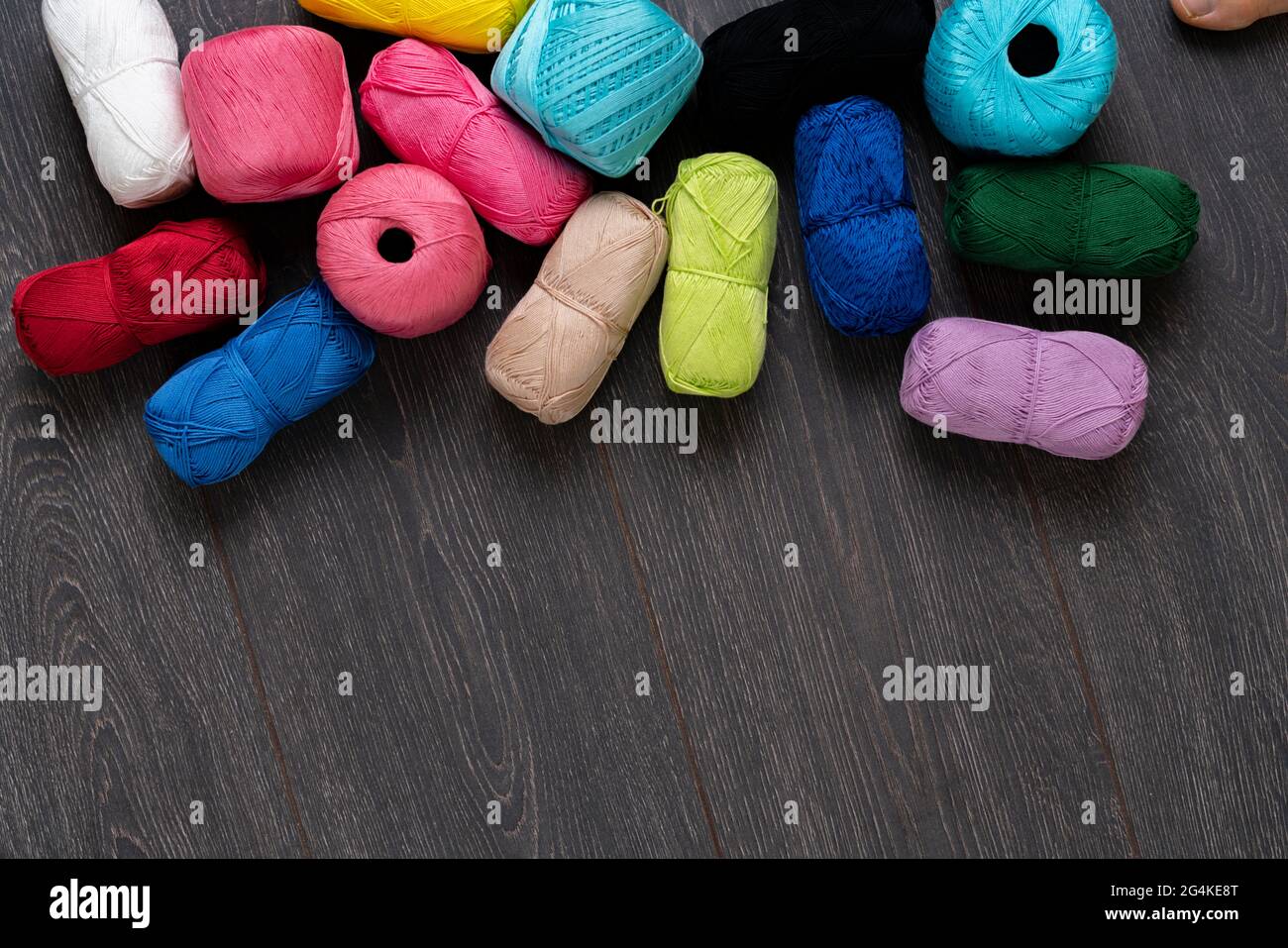 a top view of the set of different coloful knitting yarn rolls on the ...
