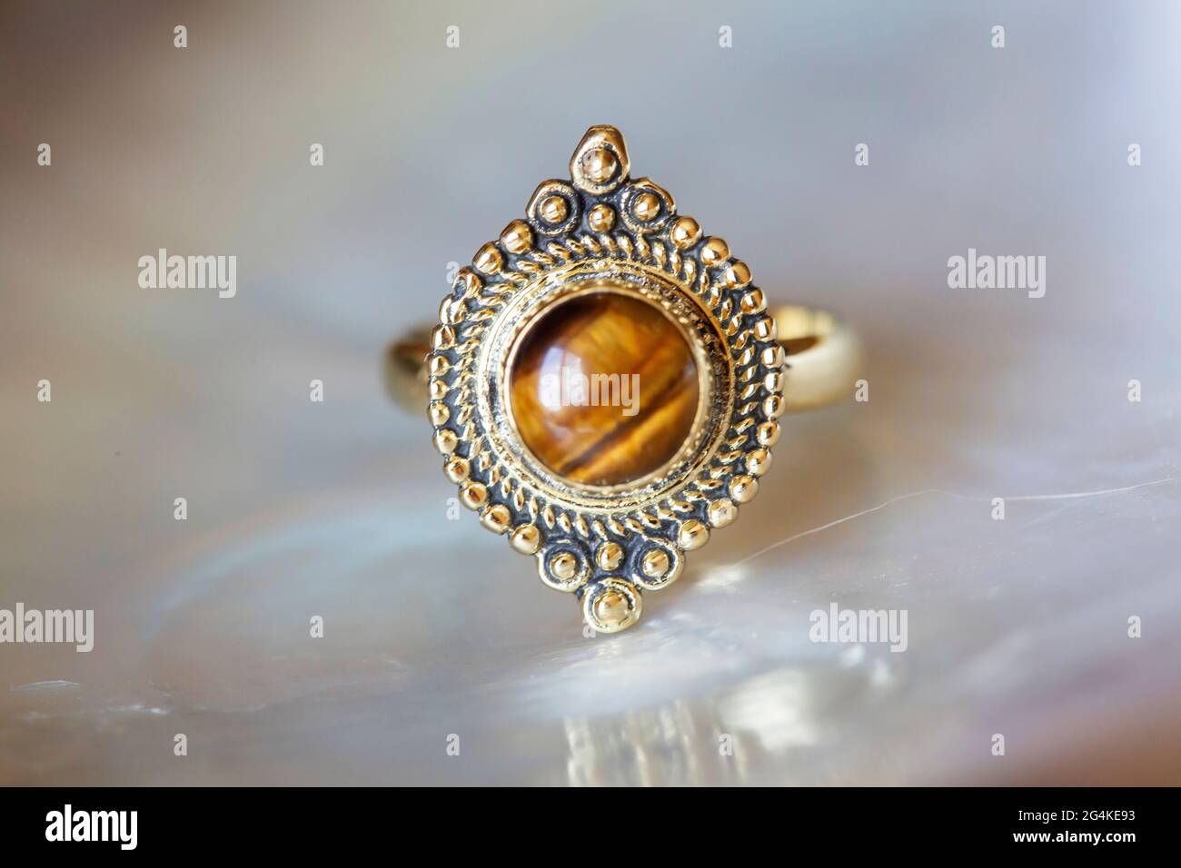 Brass ring in Indian oriental style on natural neutral shell background ...