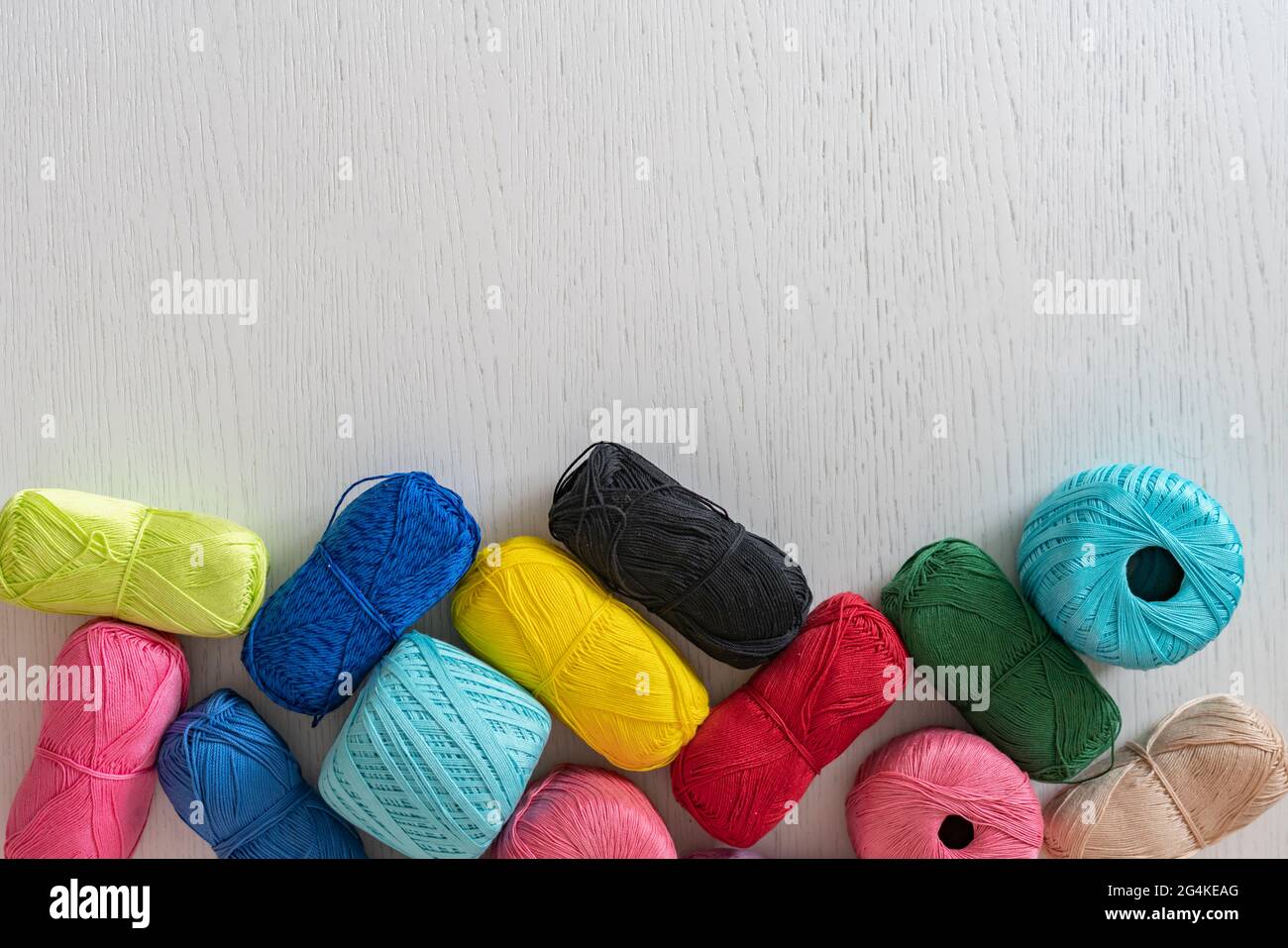 a top view of the set of different coloful knitting yarn rolls on the ...