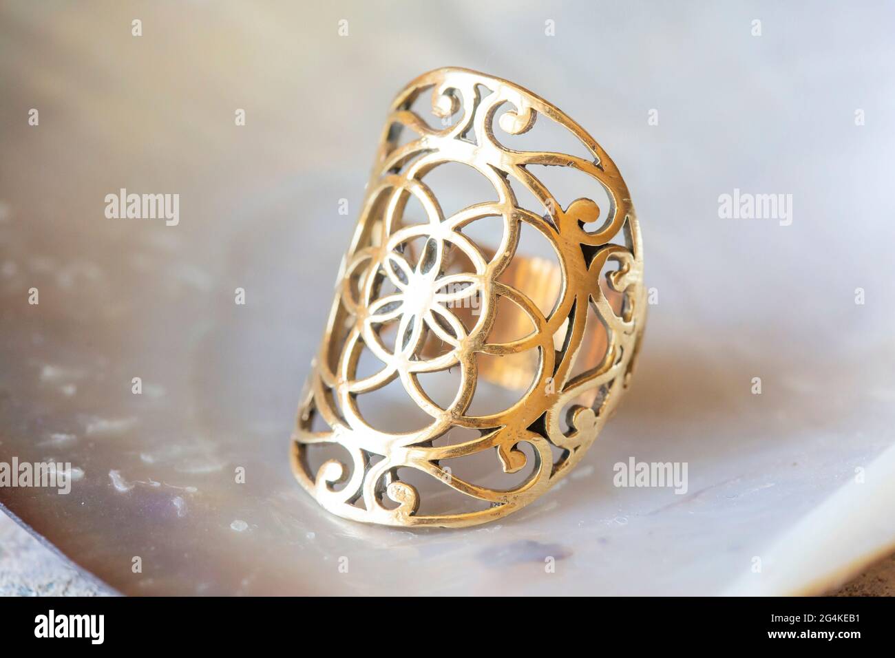 Brass ring in Indian oriental style on natural neutral shell background ...