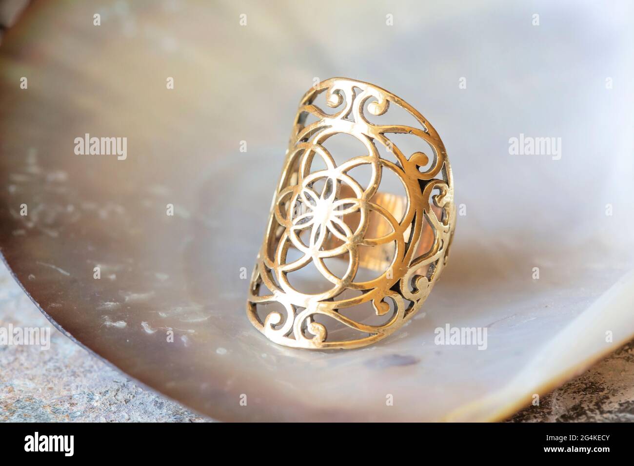 Brass ring in Indian oriental style on natural neutral shell background ...