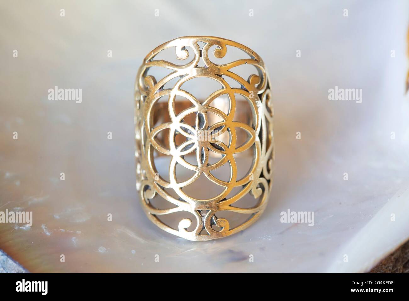 Brass ring in Indian oriental style on natural neutral shell background ...