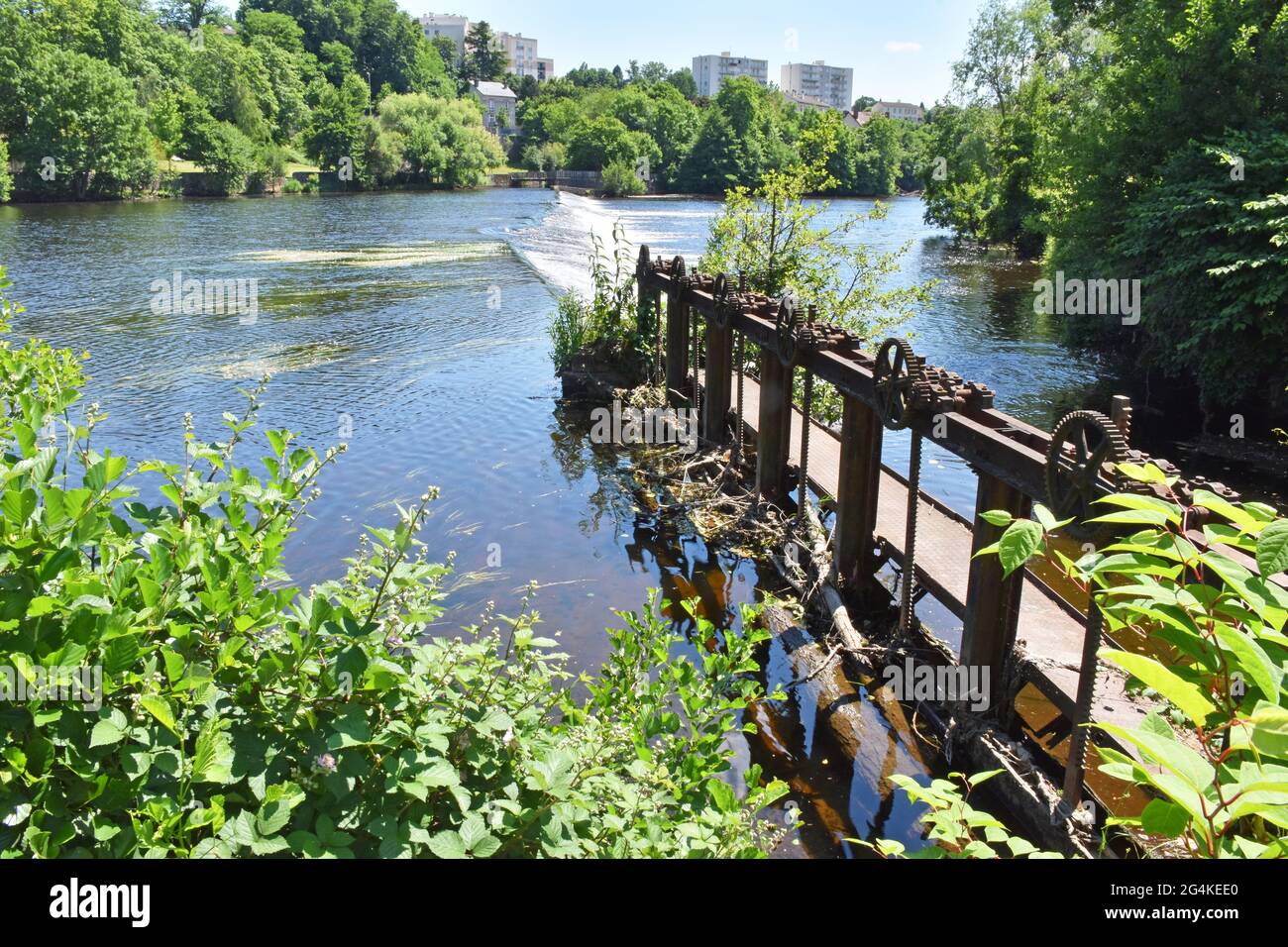 The rusting remains of a gate at one end of a weir across the river ...