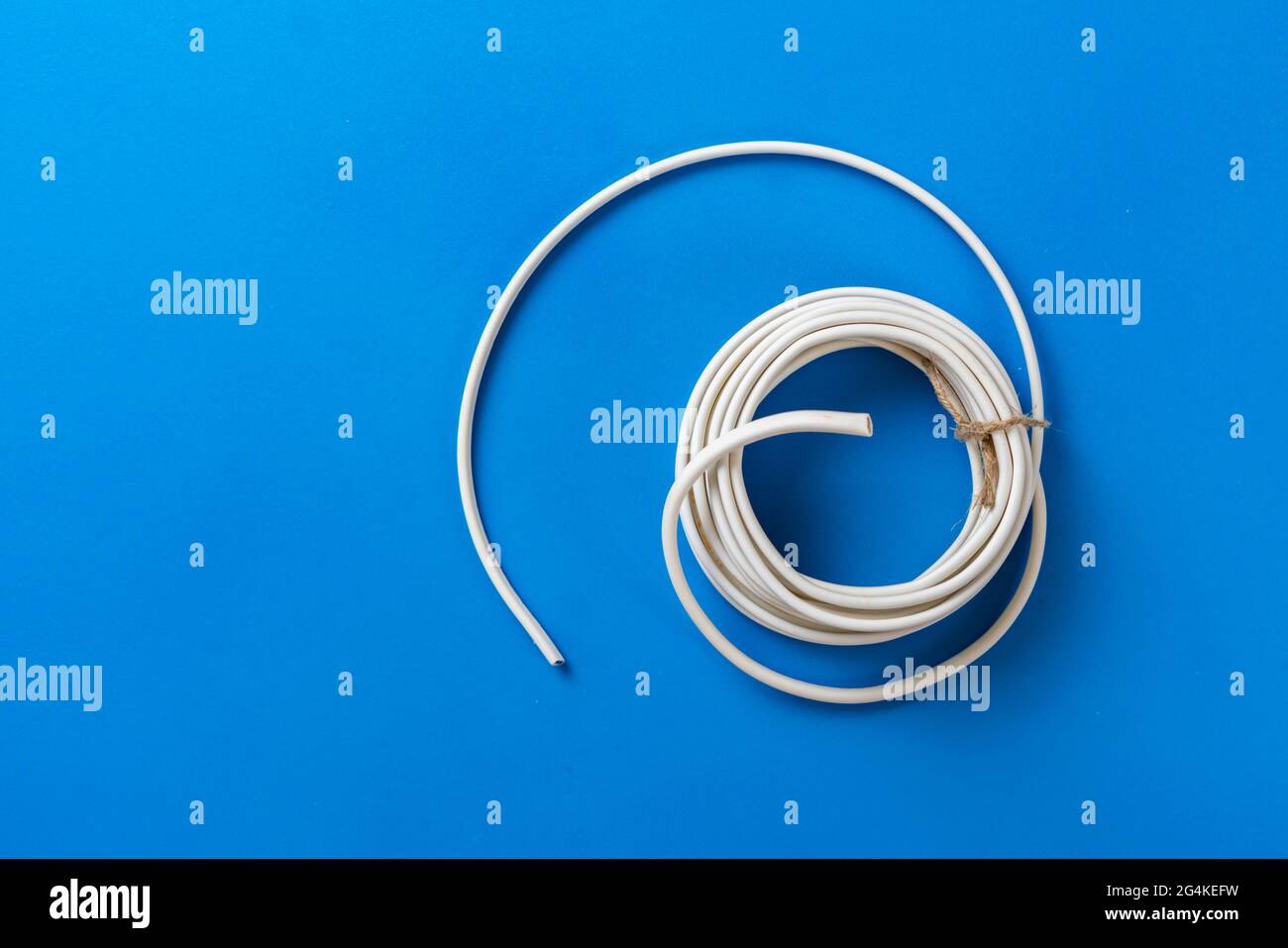 simple white wire cord flat lay on the colorful background isolated ...