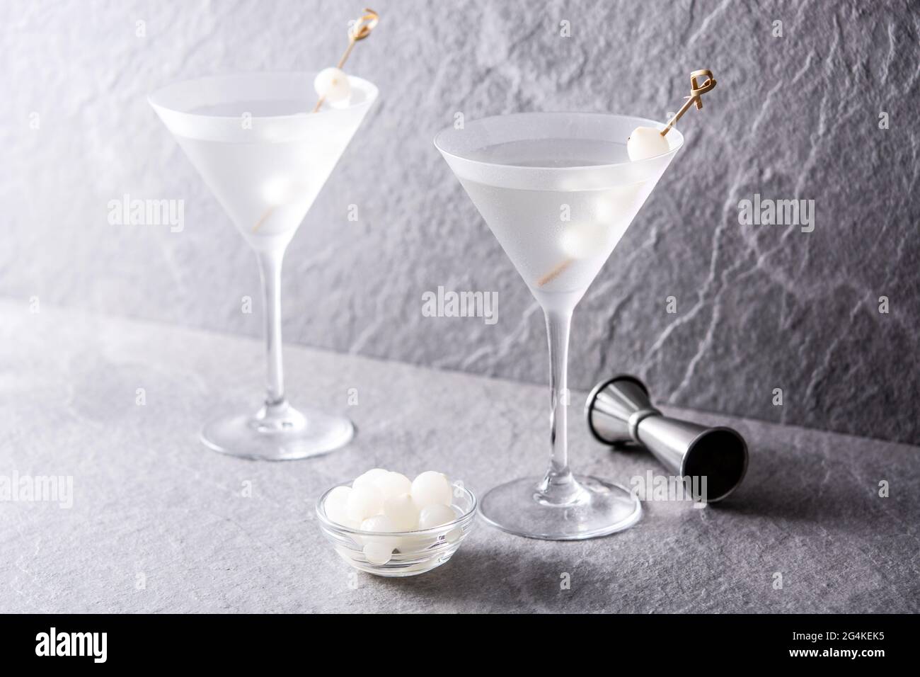 Gibson martini cocktail with onions on gray stone Stock Photo - Alamy