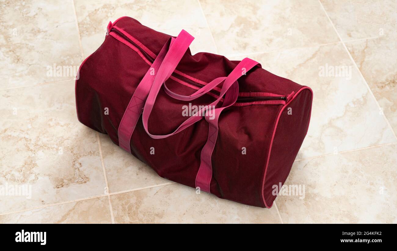 a big bag on the floor full of clothes and accessories, ready to start ...