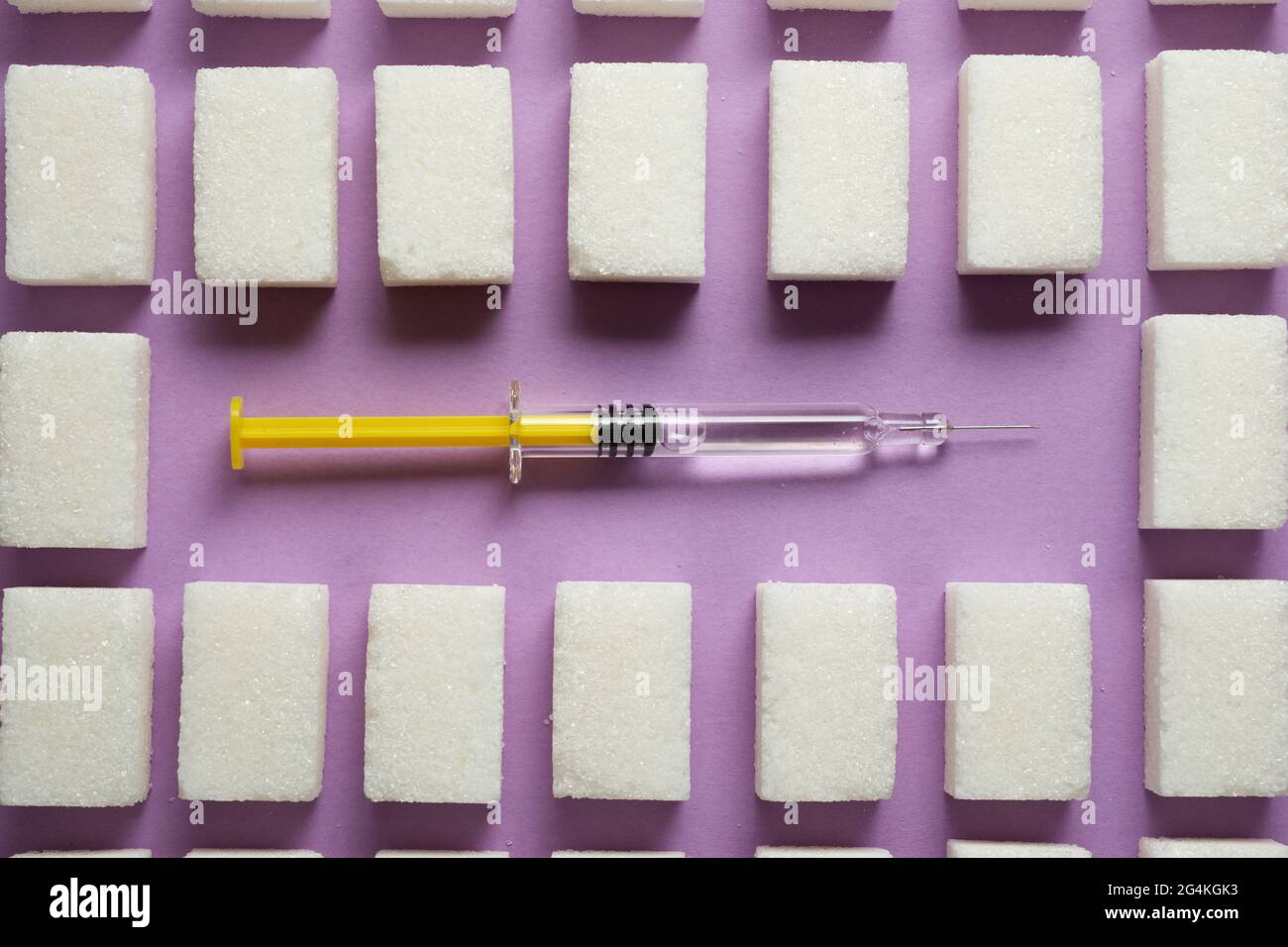 Sugar cubes and syringe on a table Stock Photo - Alamy