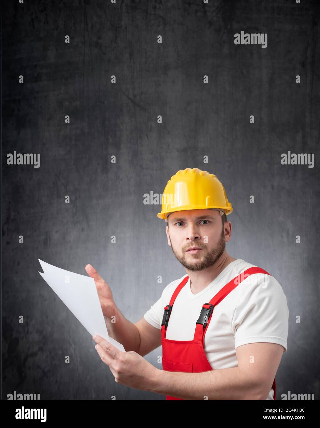 An angry construction worker holding papers or documents Stock Photo ...
