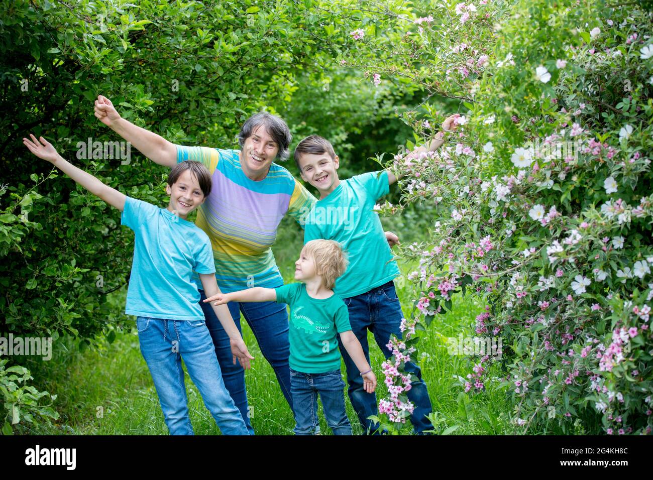 Grandmother and grandchildren, playing together in the park, springtime ...