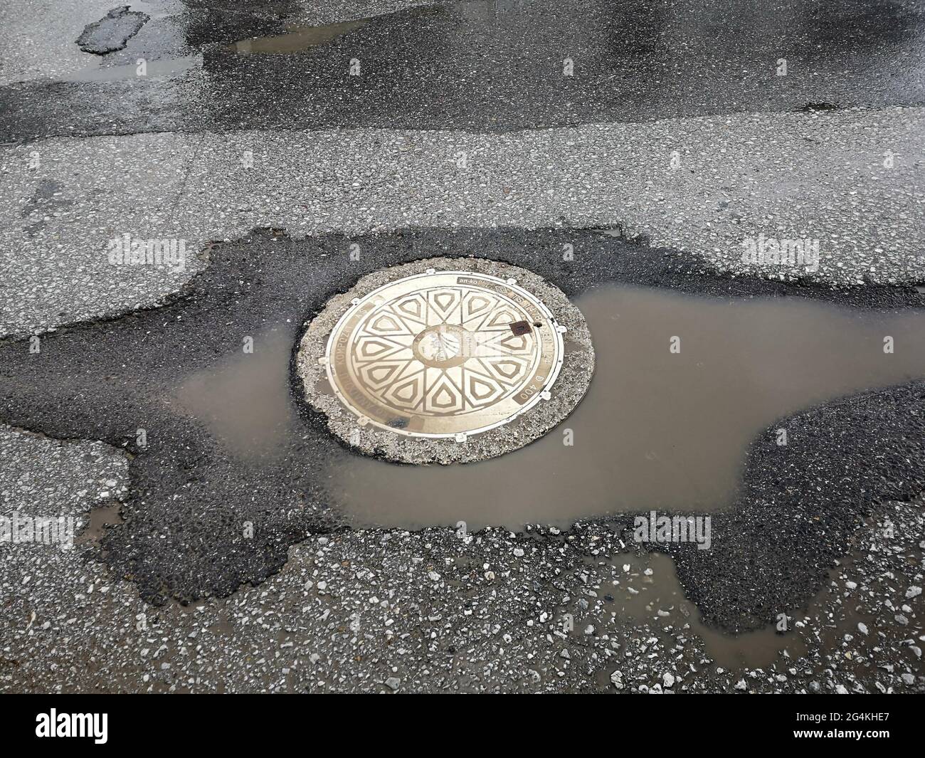 Closeup of water overflowing from a lid manhole cover of road holes ...