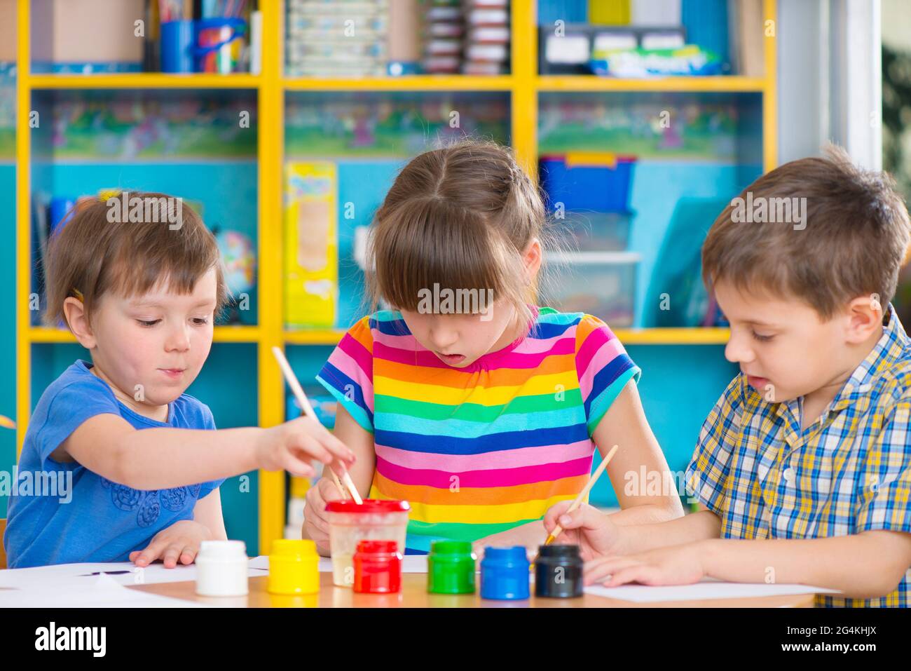 Cute little preschool children drawing with colorful paints at ...