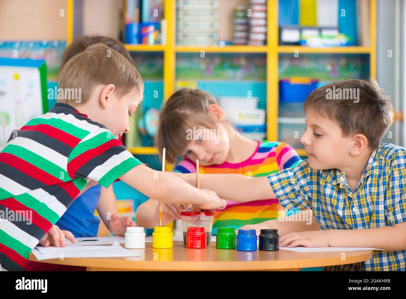 Cute little preschool children drawing with colorful paints at ...