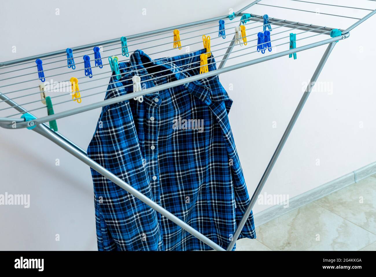 a simple foldable rack dryer with clean washed clothes textile, drying ...