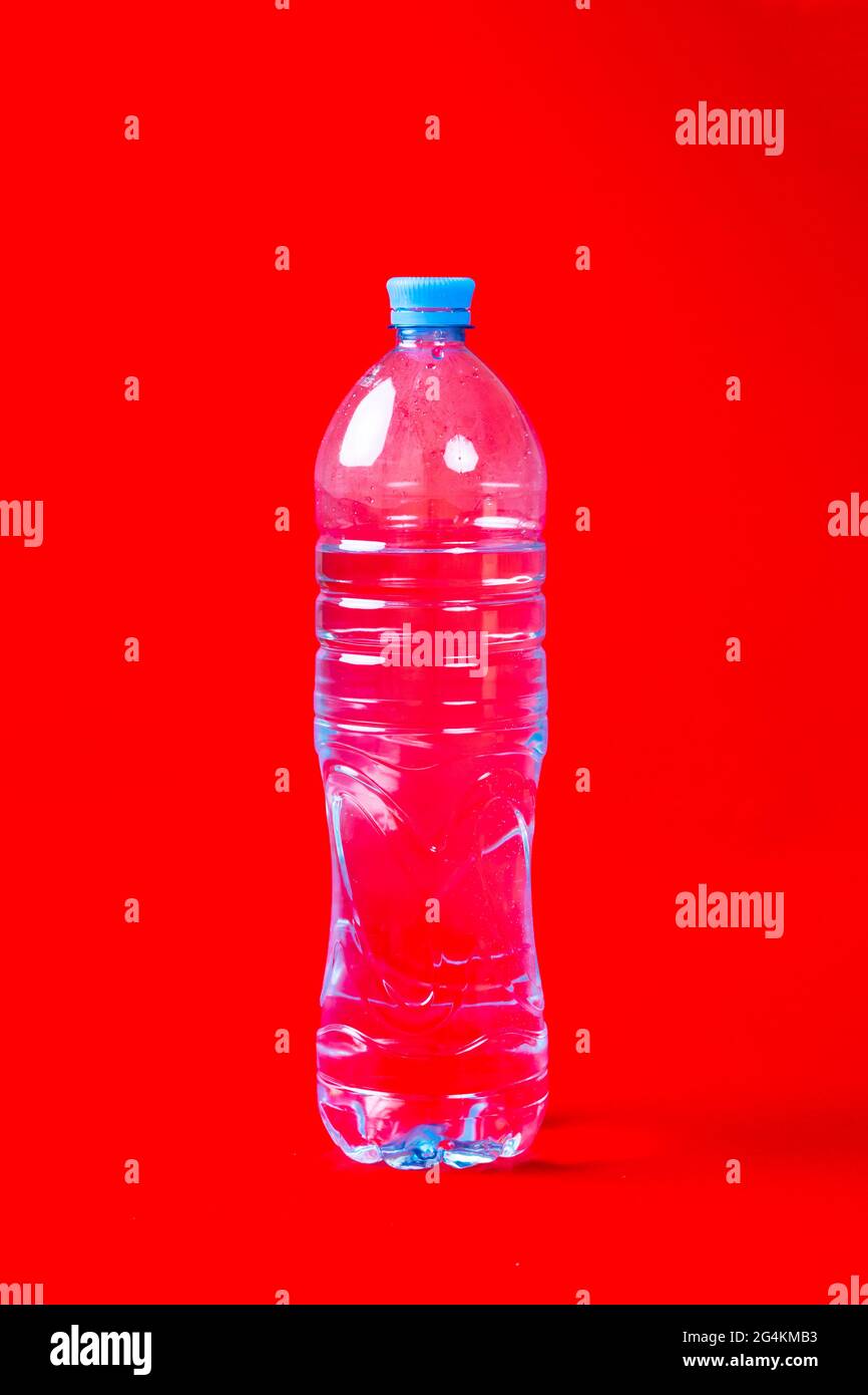 a simple plastic bottle with pure water against the colorful background ...