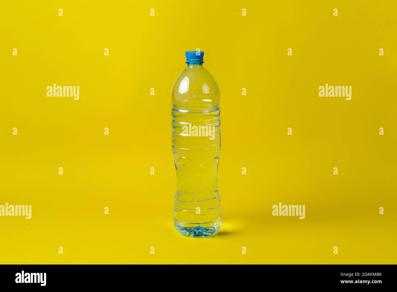 a simple plastic bottle with pure water against the colorful background ...