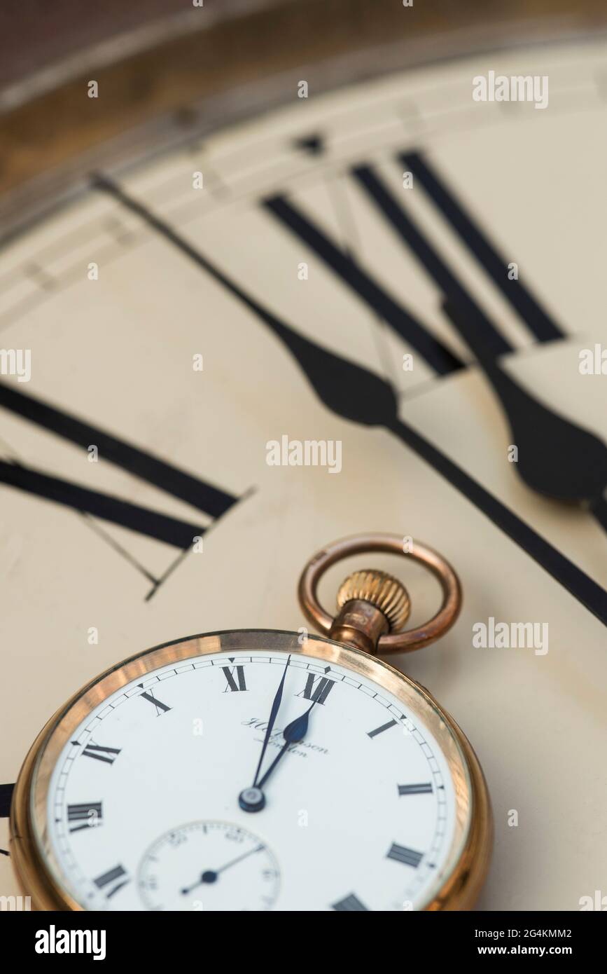 Two minutes to midnight. A pocket watch laid on a clock face Stock ...