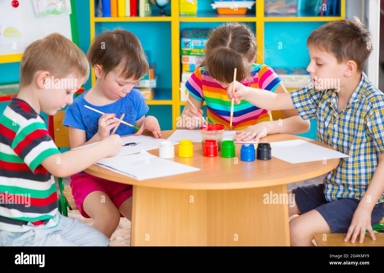 Cute little preschool children drawing with colorful paints at ...