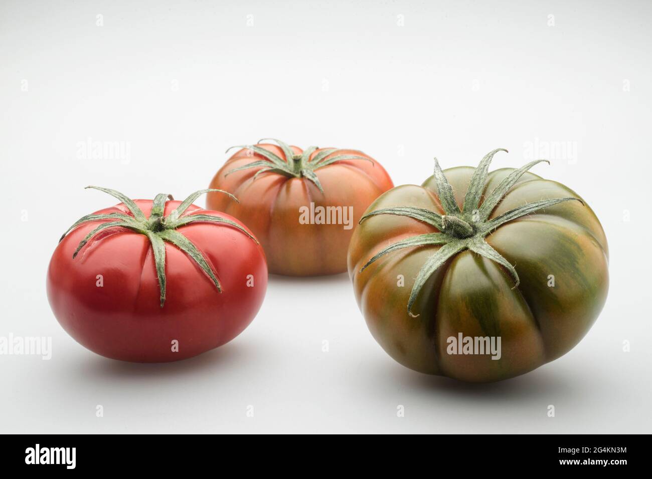 Tomatoes red orange green on white, Sicily, Italy, Europe Stock Photo ...