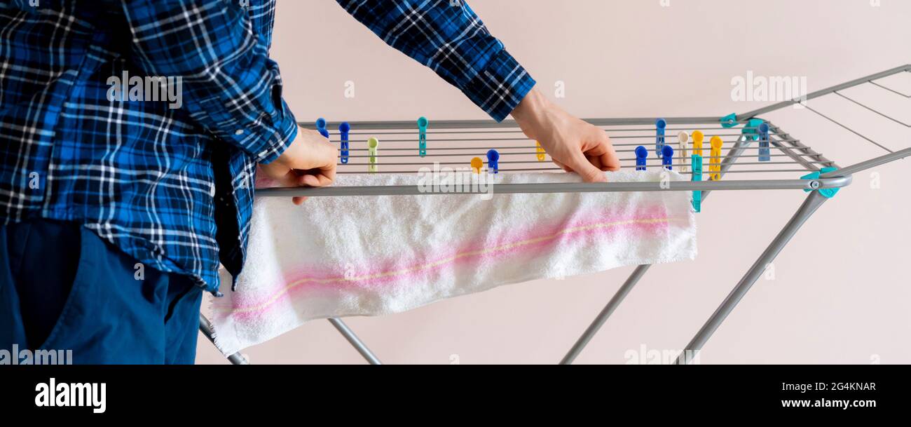 putting some new clean clothes on the cloth hanger at home Stock Photo ...
