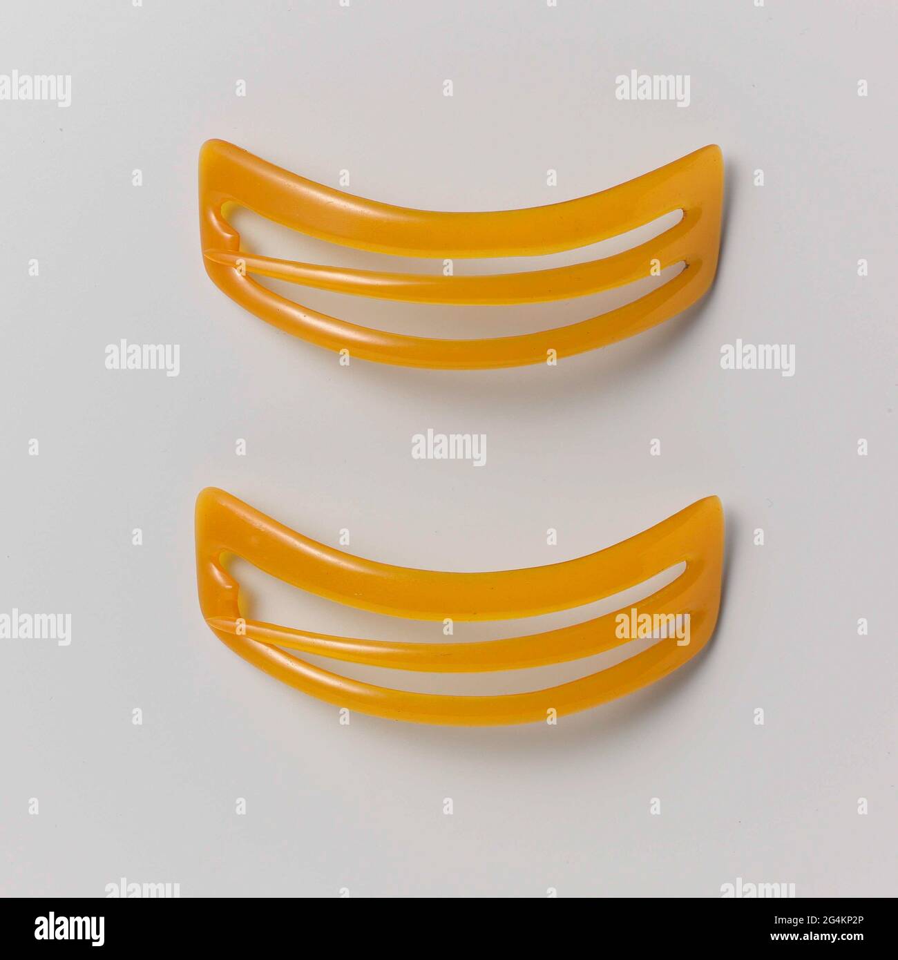 . Hairpin of unmerked orange yellow plastic, in curved trapezoidal ...