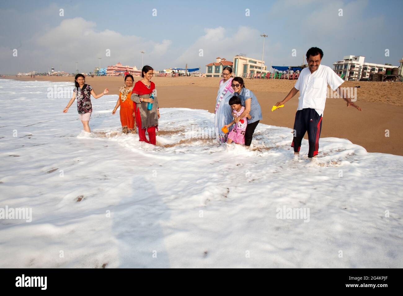 tourists enjoying waves at the popular sea beach of Puri, Odisha, India ...