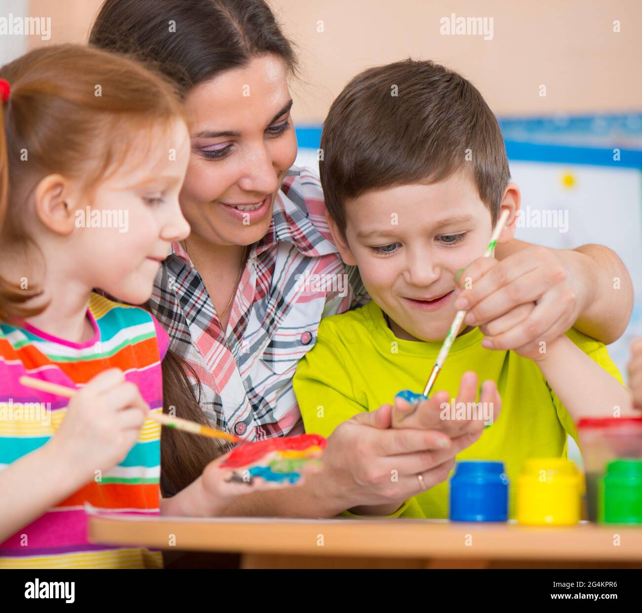Cute little children drawing with teacher at preschool class Stock ...