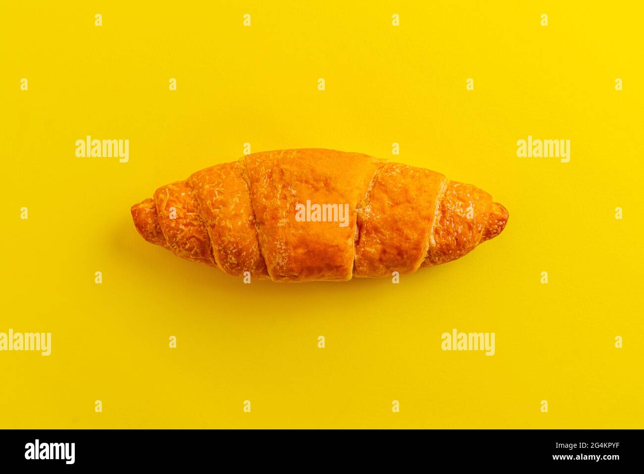 a simple croissant isolated against the colrful background, traditional ...