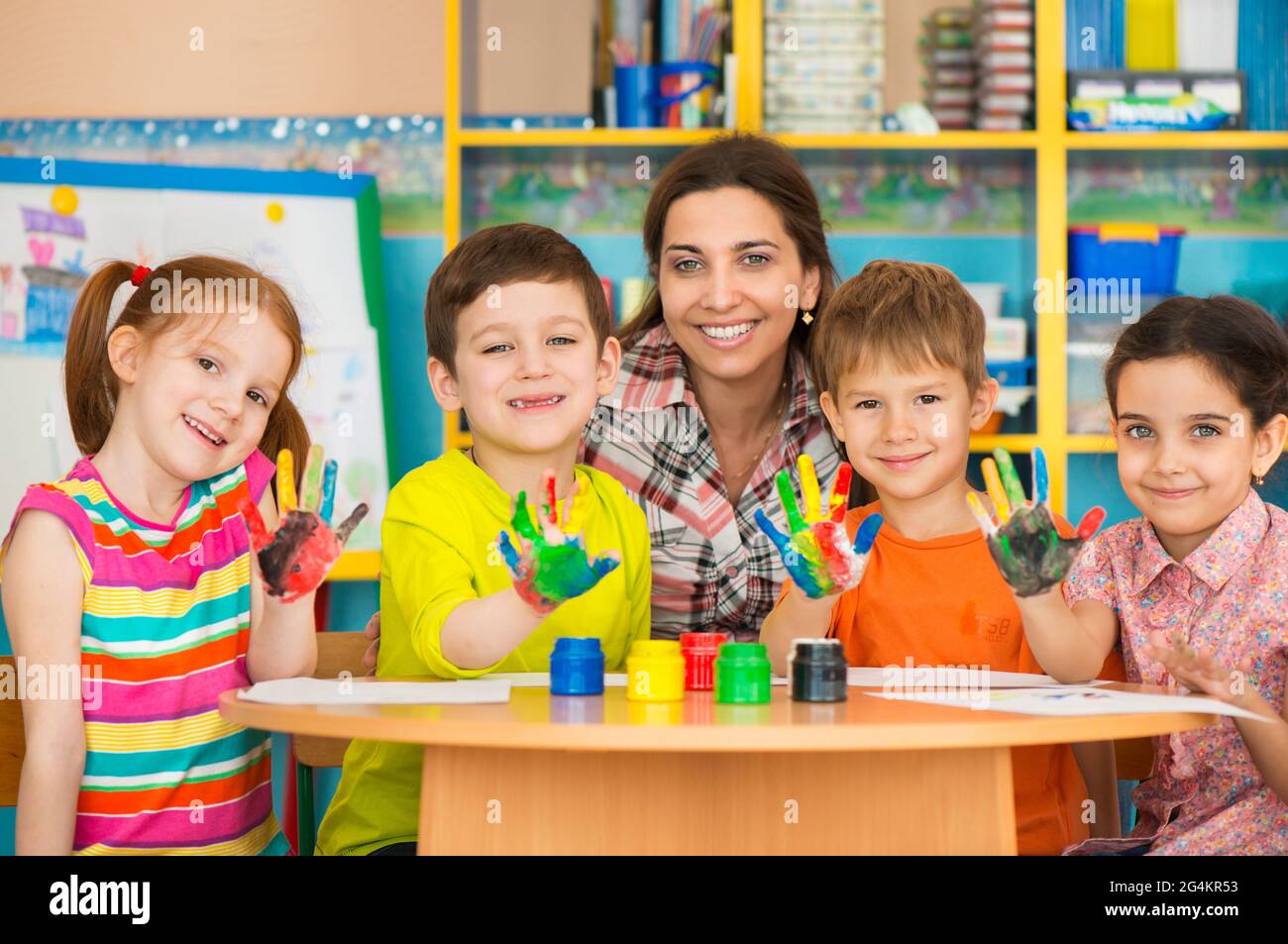 Cute little children drawing with teacher at preschool class Stock ...