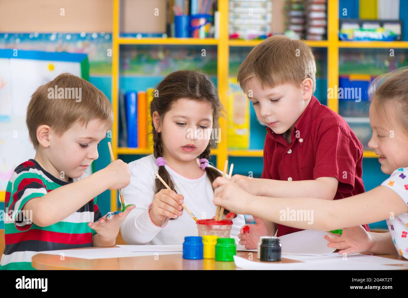 Cute little preschool children drawing with colorful paints at ...