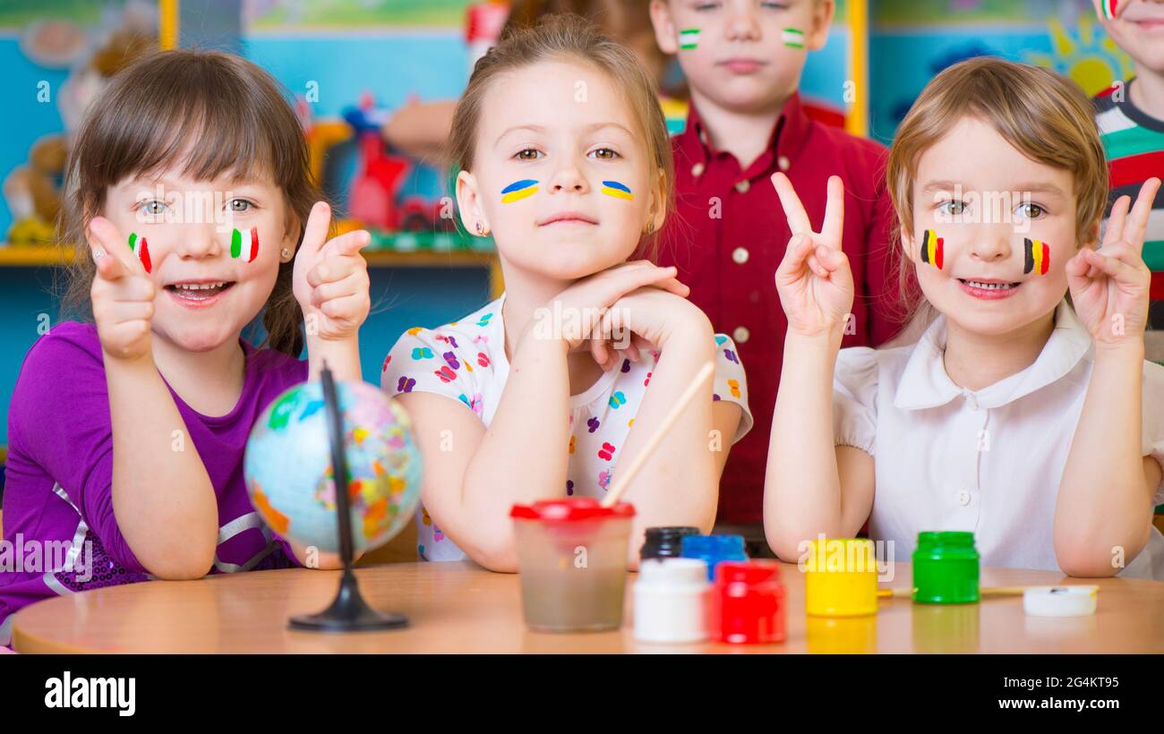 Happy children in language camp studying geography Stock Photo - Alamy