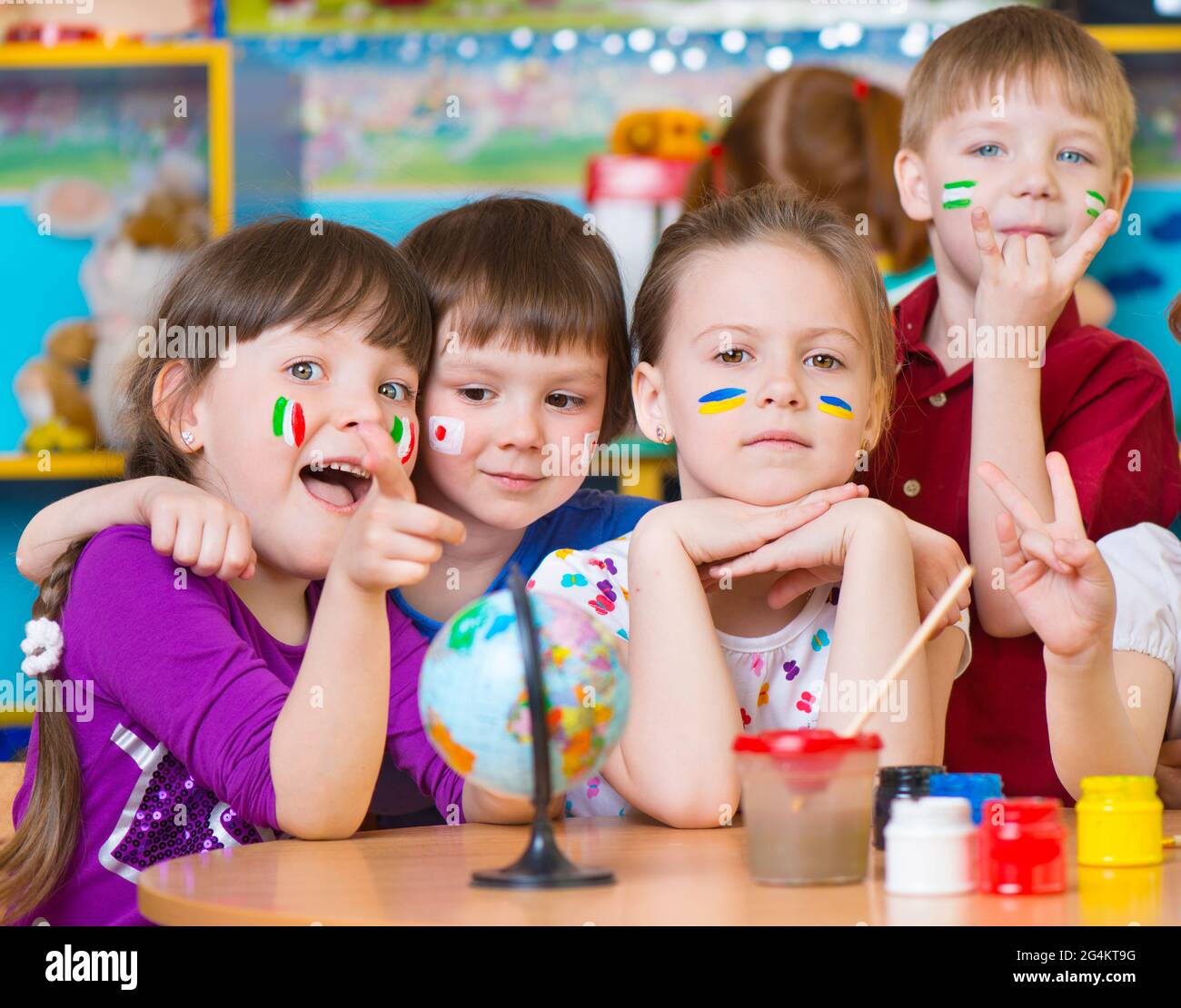 Happy children in language camp studying geography Stock Photo - Alamy