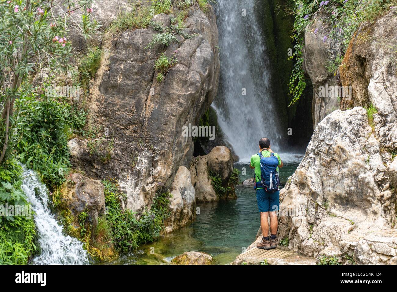 Tourist taking a photo of the Algar Waterfalls Stock Photo - Alamy