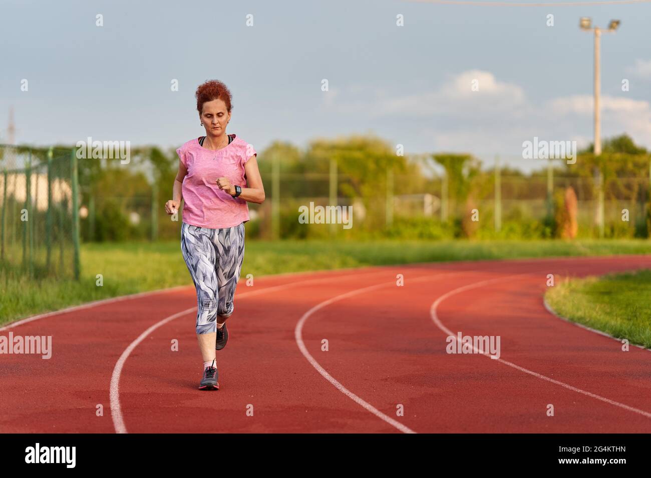 Woman running on a track hi-res stock photography and images - Alamy