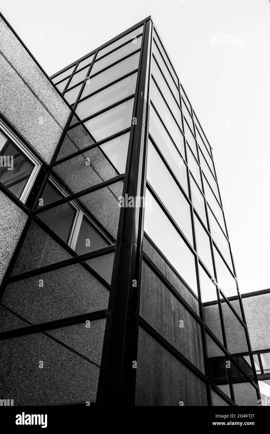 Vertical grayscale shot of a modern glass building Stock Photo - Alamy