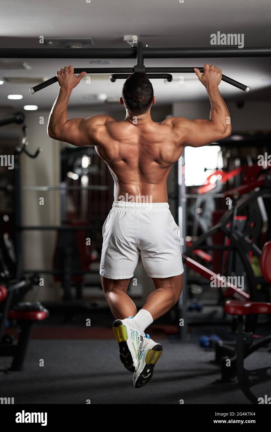 Man doing pull-ups in the fitness gym at the bar Stock Photo - Alamy