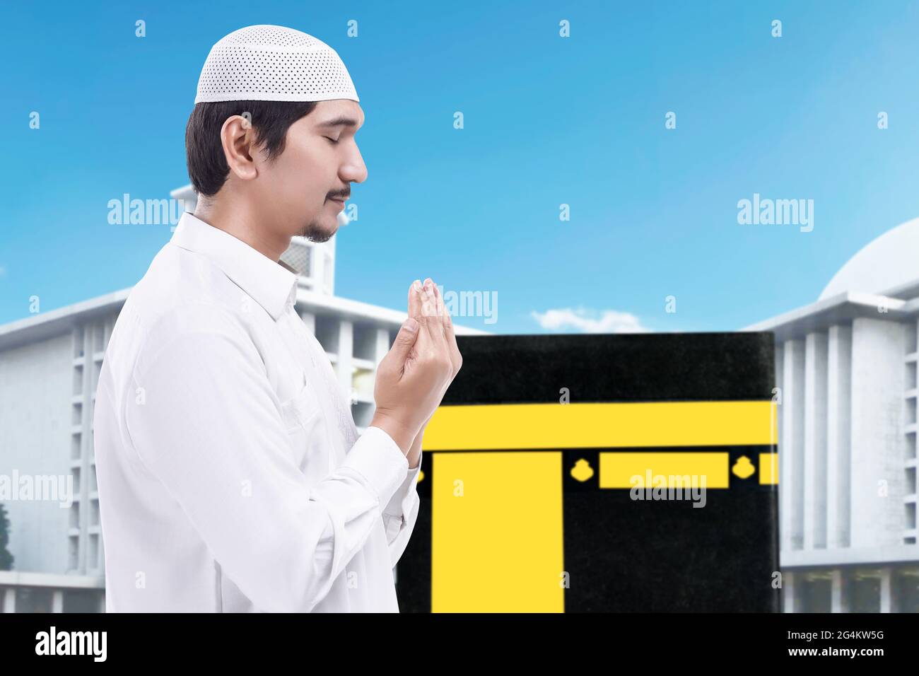 Asian Muslim man standing and praying with Kaaba view and blue sky ...
