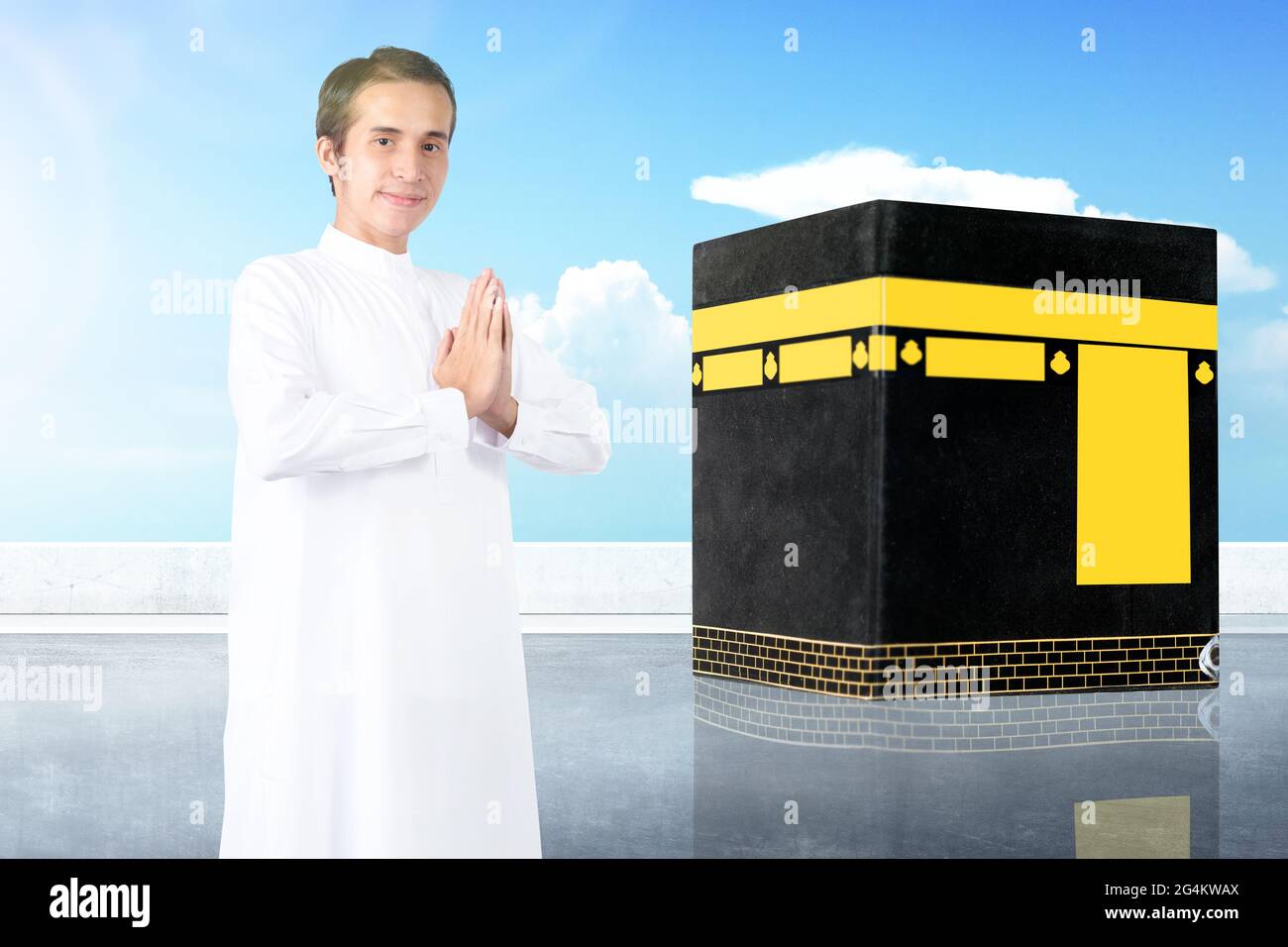 Asian Muslim man standing with greetings gesture with Kaaba background ...