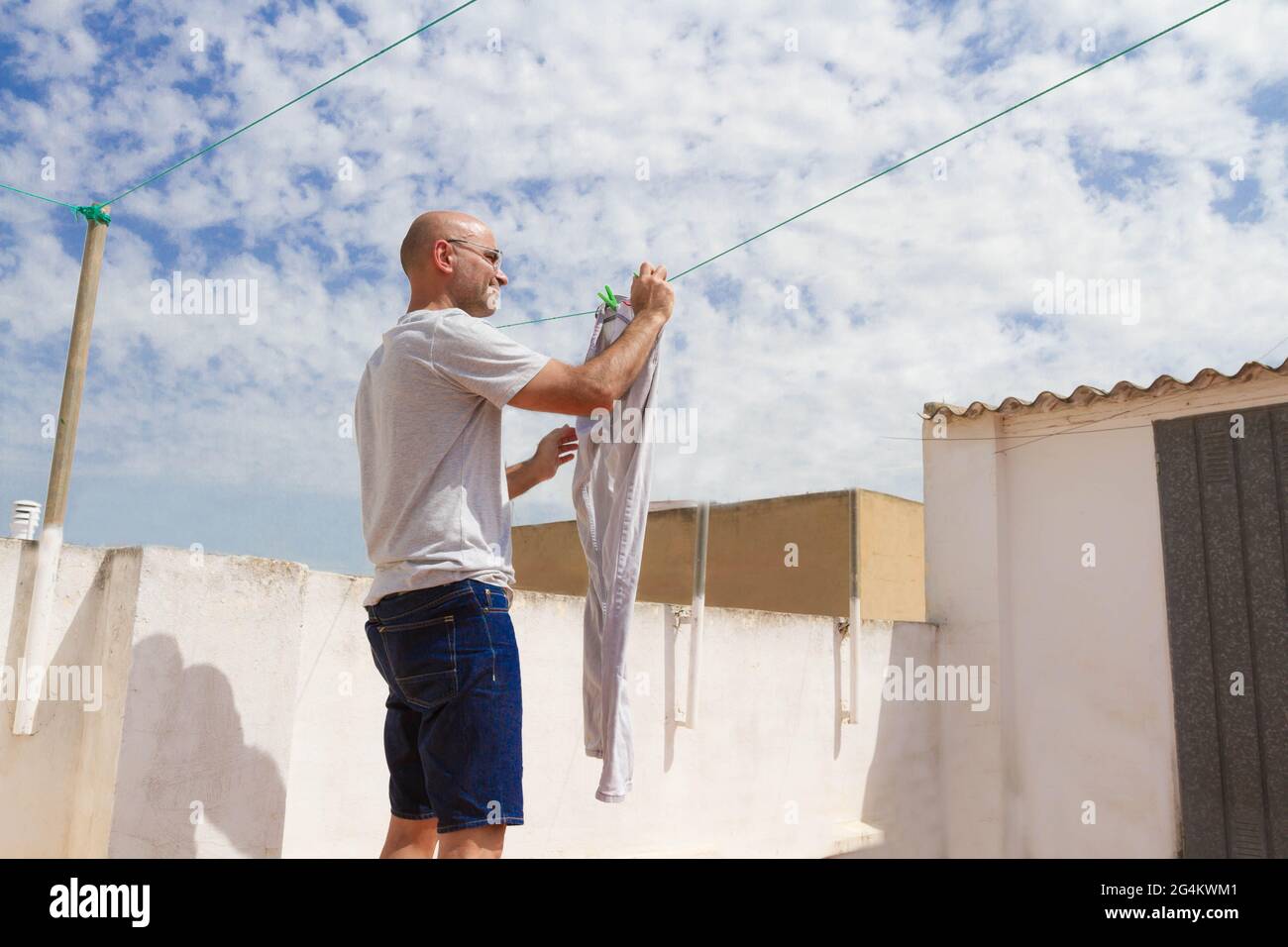 Spanish housekeeper laying the laundry on the roof of a house Stock ...