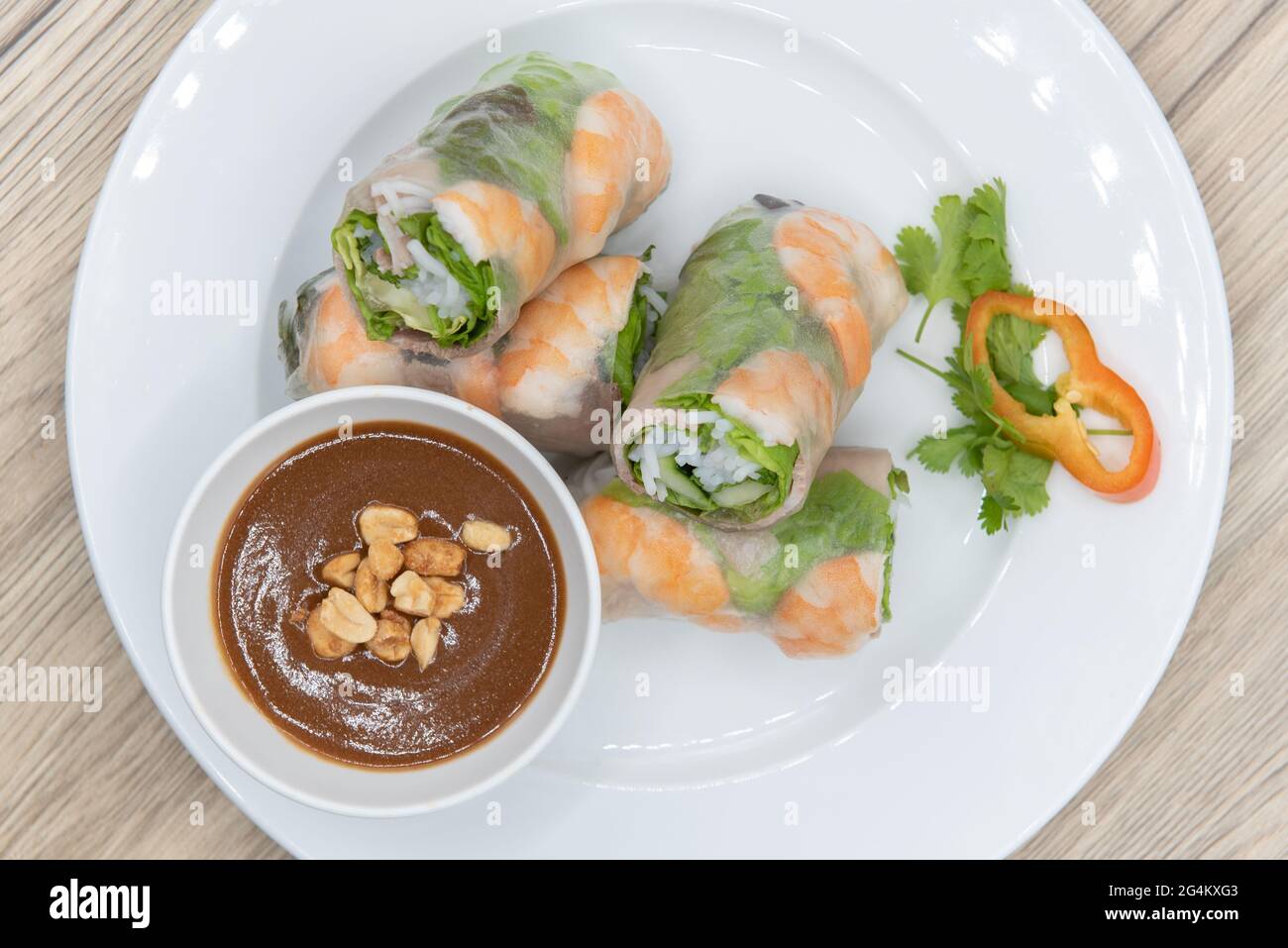 Overhead view of hearty plate of tofu spring rolls loaded and sliced ...