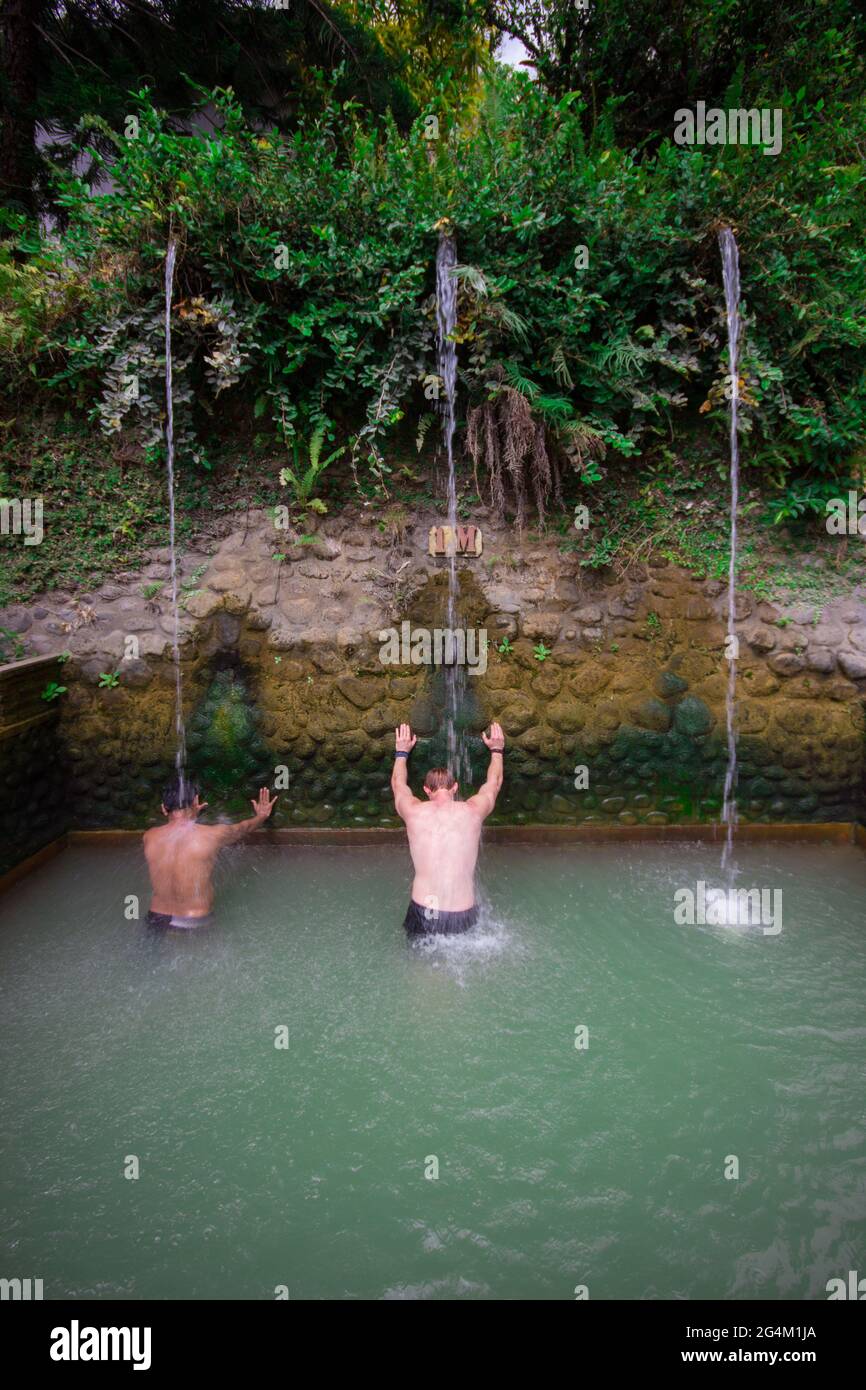 People take a bath in thermal Banjar Tega hot springs, Bali, Indonesia ...