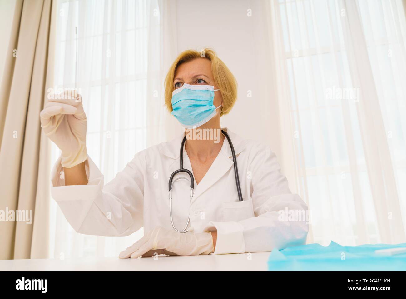 Doctor is checking the covid 19 with a tester Stock Photo - Alamy